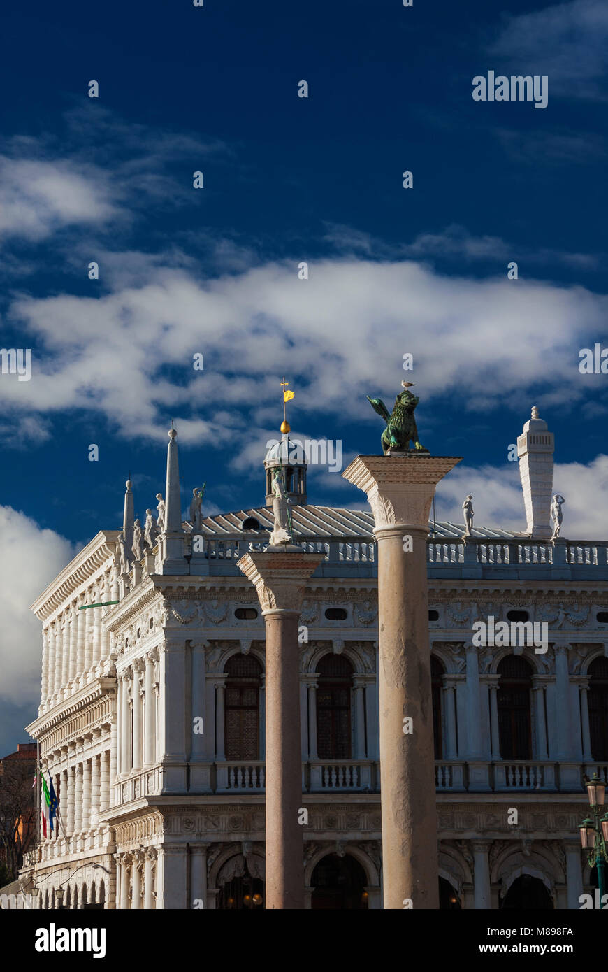 Saint Mark square with winged lion ancient column and old library at ...