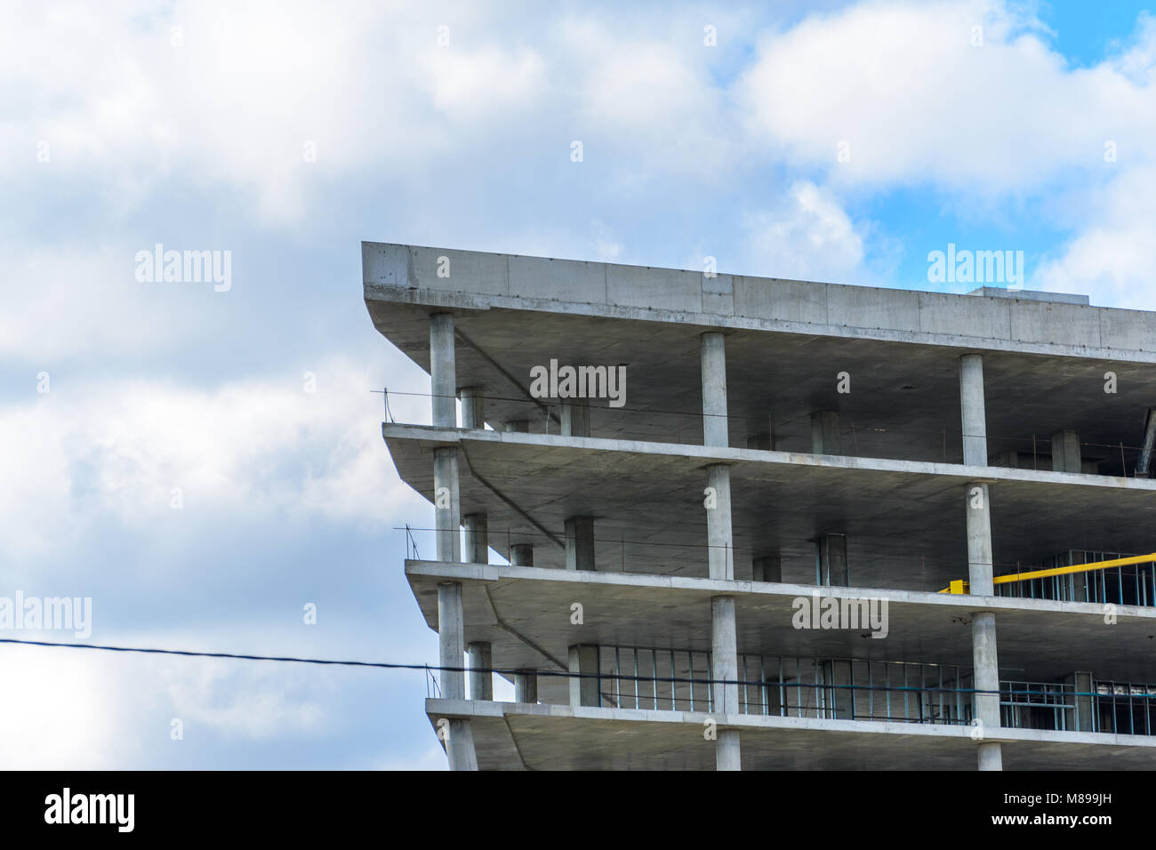 Reinforced concrete skeleton of an unfinished building against the ...