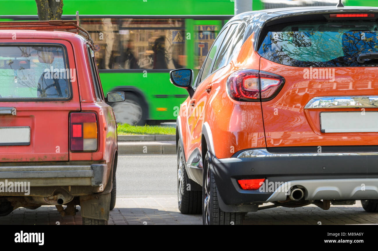 Rear view of two cars of different eras standing side by side in the ...