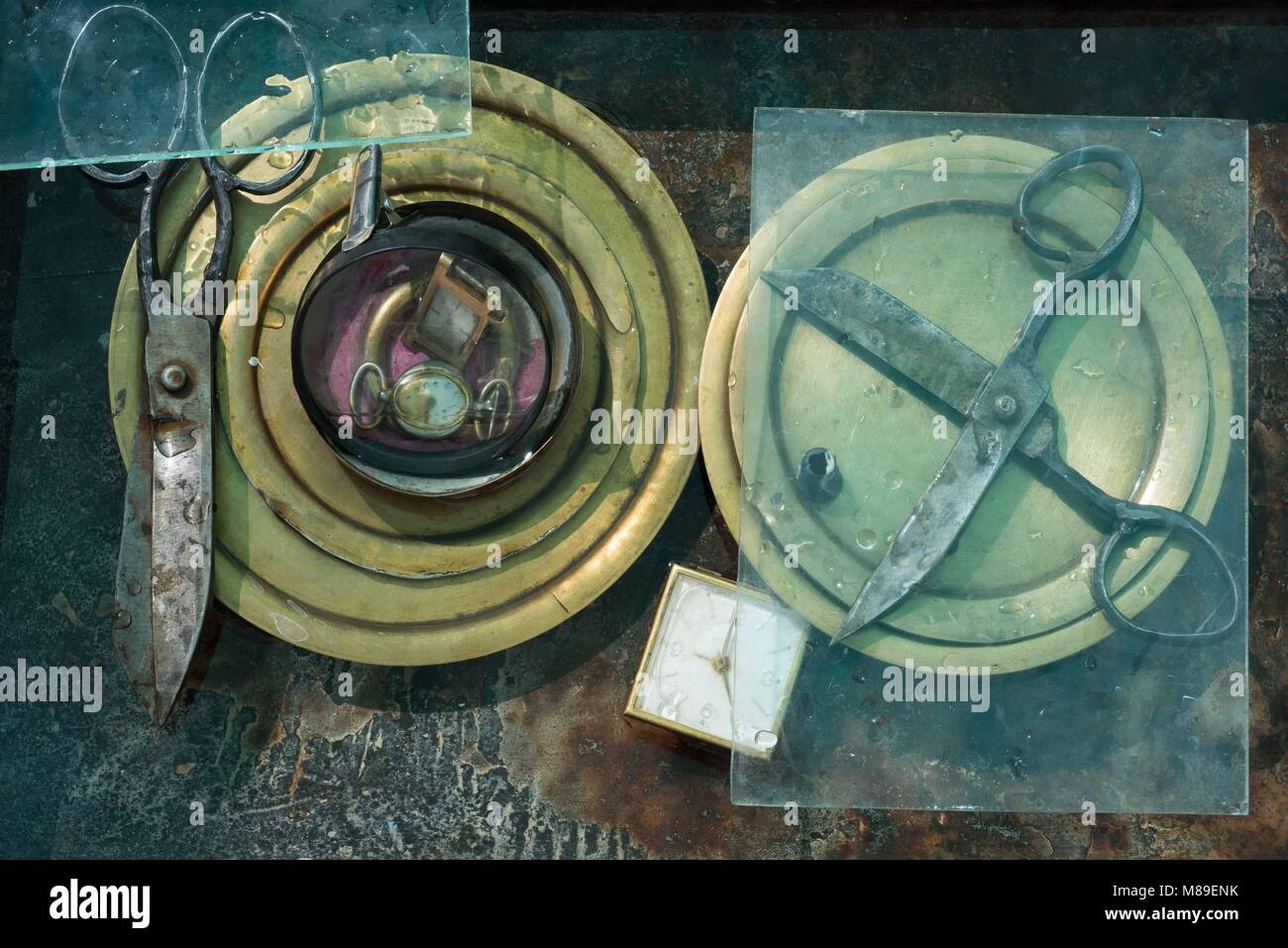 Art still life with two old metal big black scissors on a copper round ...