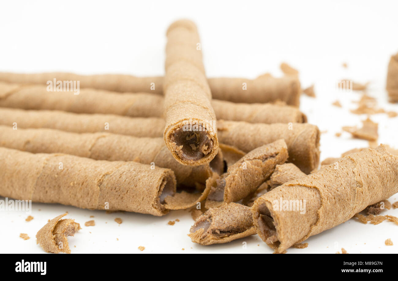 Waffle rolls stick closeup on white, shallow dof Stock Photo - Alamy