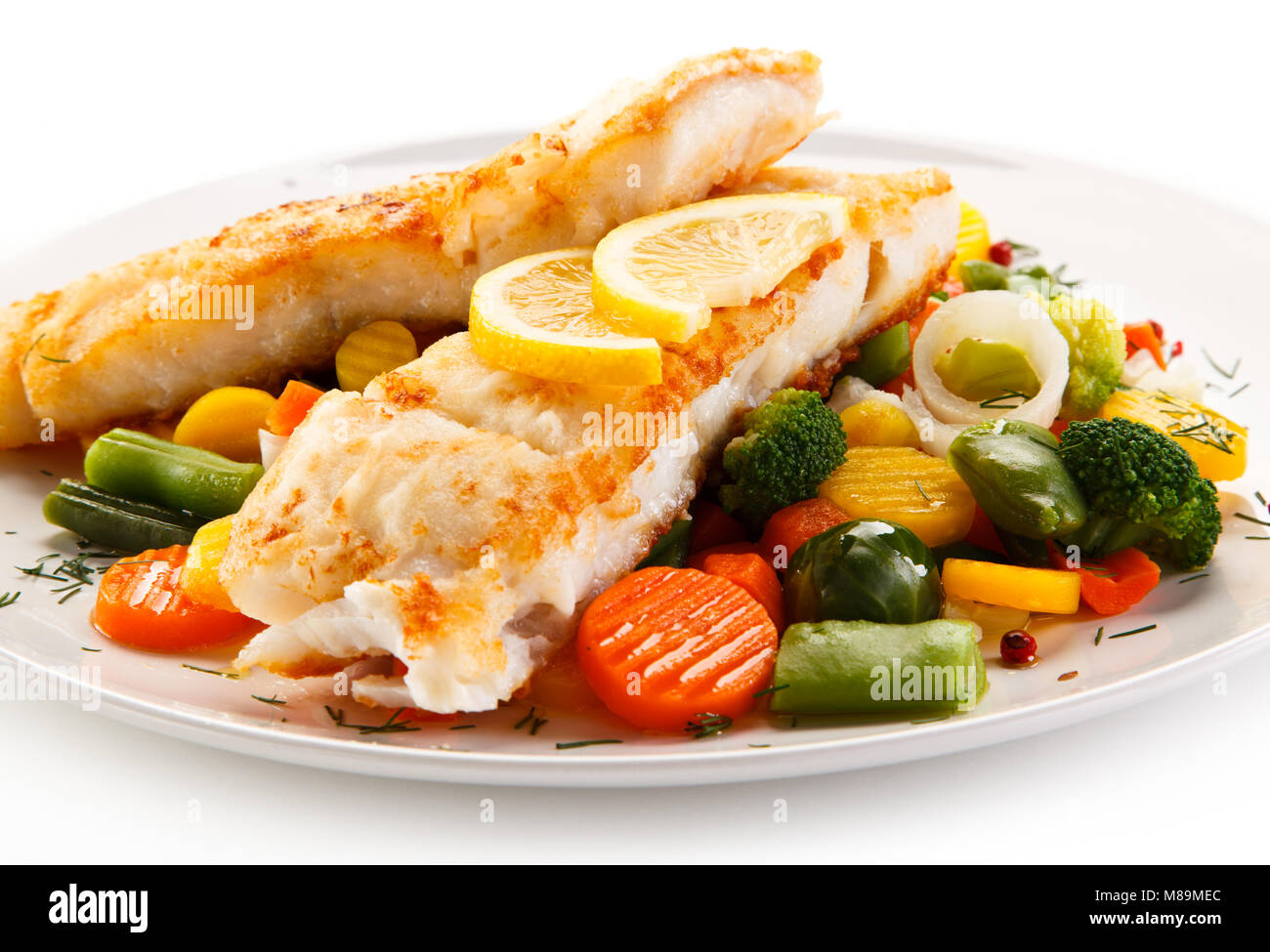 Fish dish - fried fish fillet and vegetables Stock Photo - Alamy