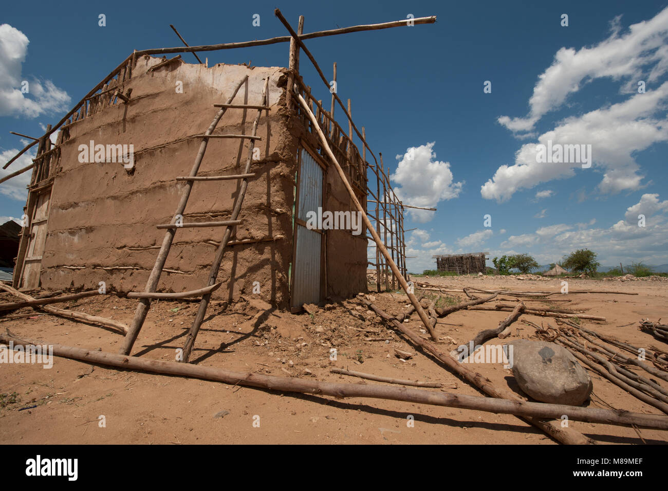 Construction of a poor clay hut: the wooden slats stack the walls ...