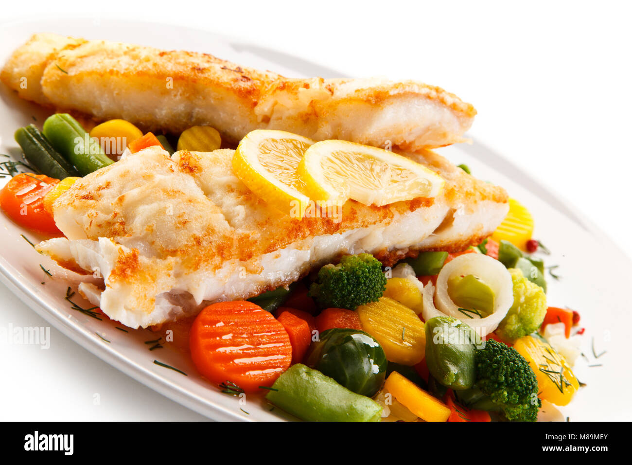 Fish dish - fried fish fillet and vegetables Stock Photo - Alamy