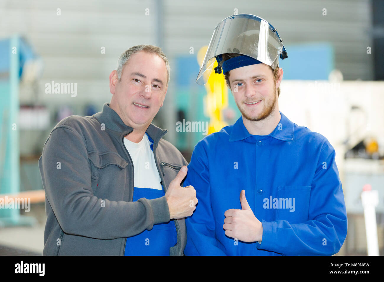 engineer teaching apprentice to use tig welding machine Stock Photo - Alamy