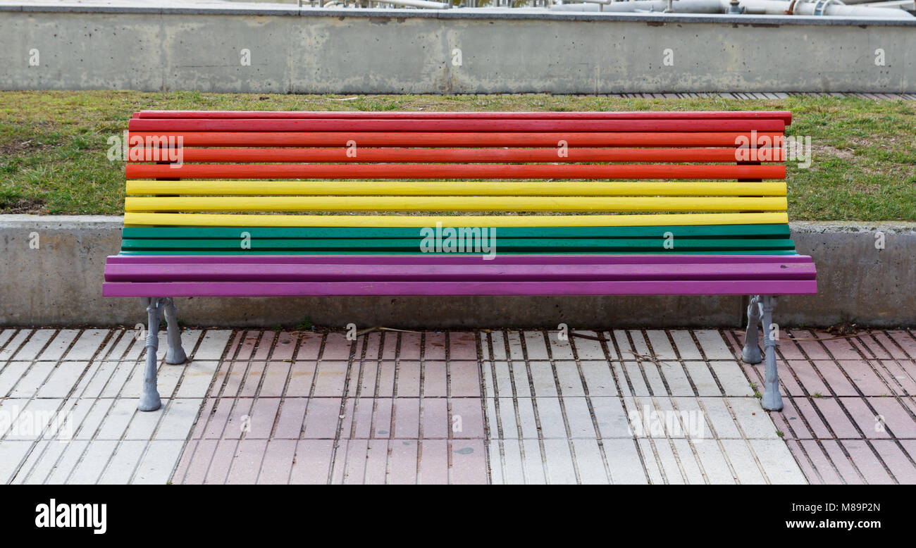 Bench painted in rainbow colors in the street Stock Photo - Alamy