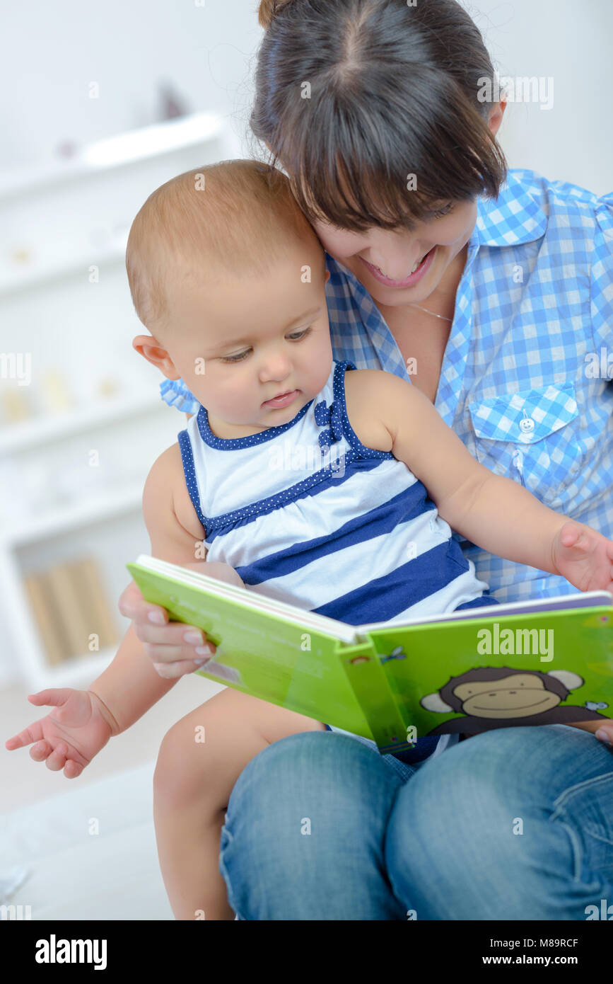 mother and baby reading a book together Stock Photo - Alamy