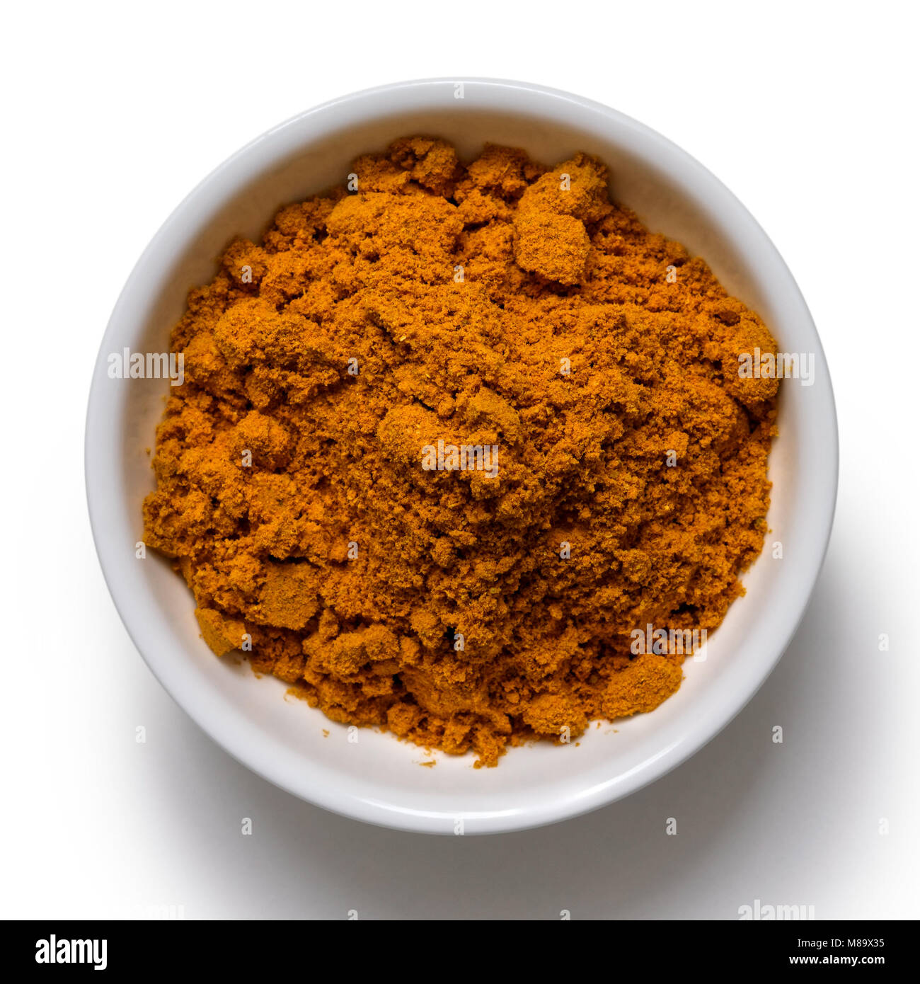 Curry powder in white ceramic bowl isolated on white from above Stock ...