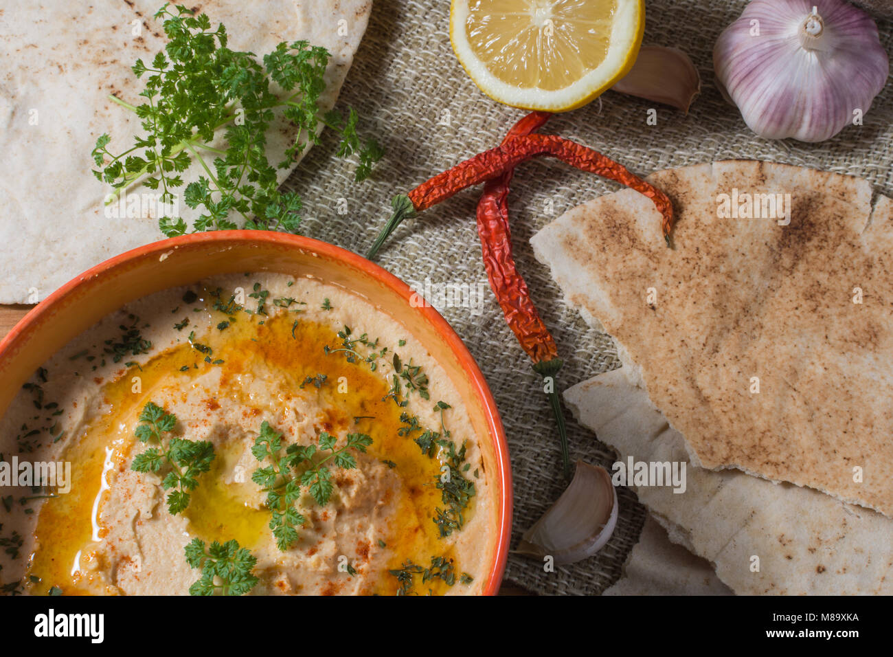 Traditional hummus salad on rustic wooden table Stock Photo - Alamy