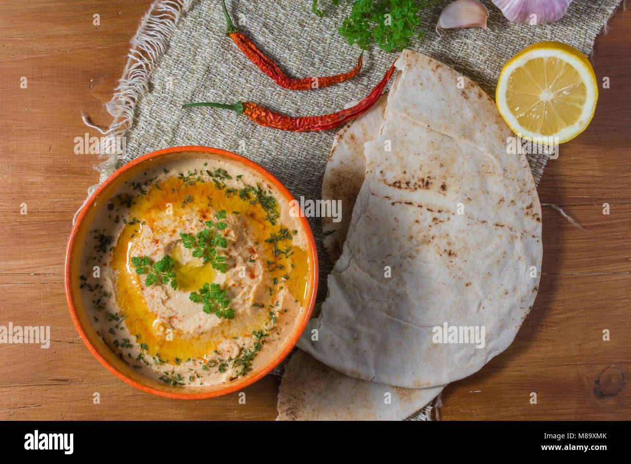 Traditional hummus salad on rustic wooden table Stock Photo - Alamy