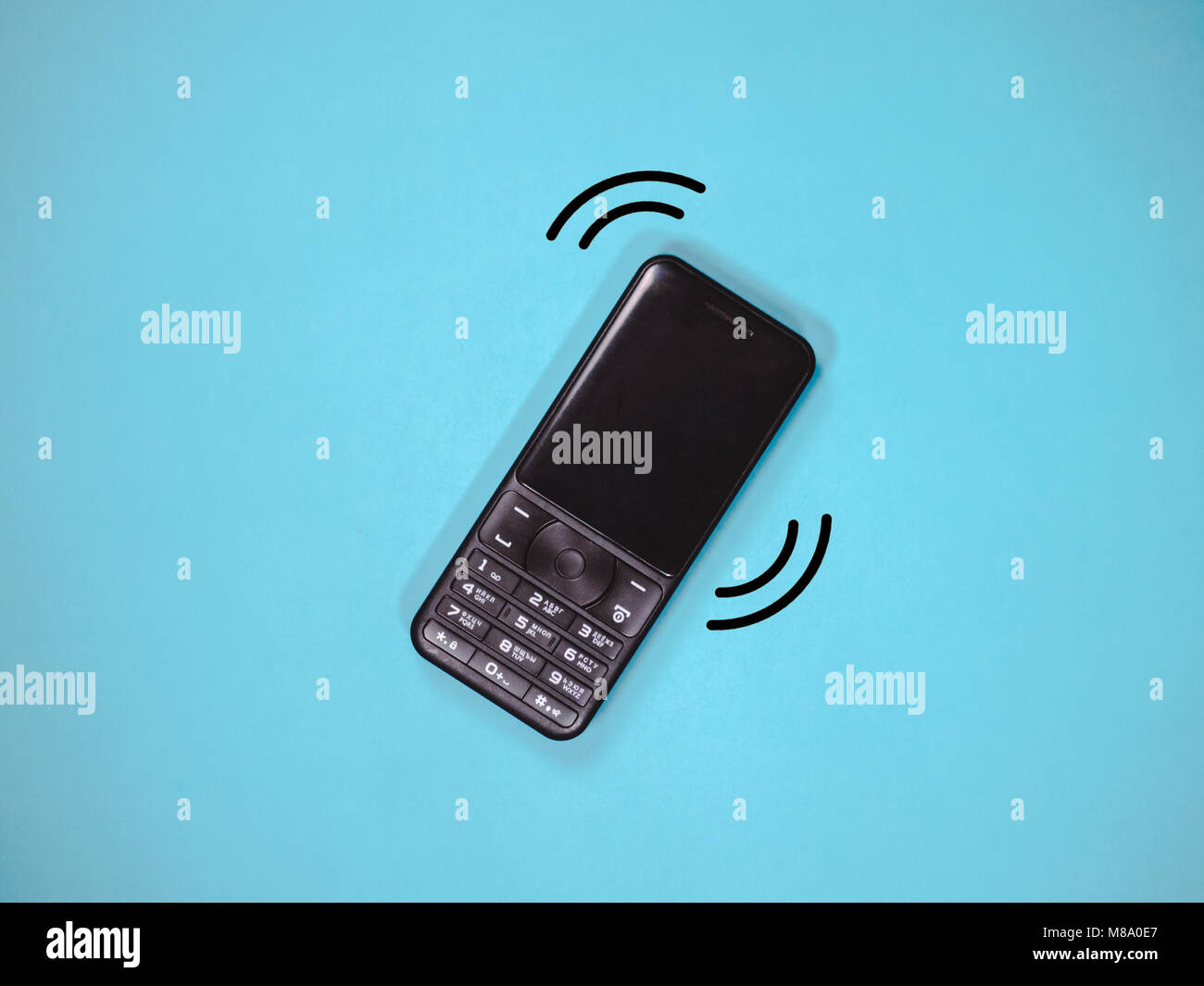 Old mobile telephone is ringing isolated on blue background Stock Photo ...