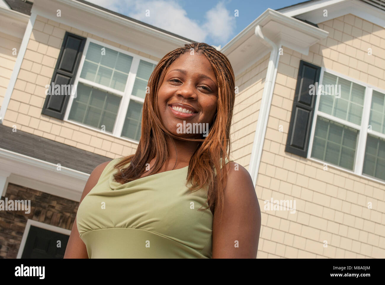 A young African American woman at her newly purchased home Stock Photo ...