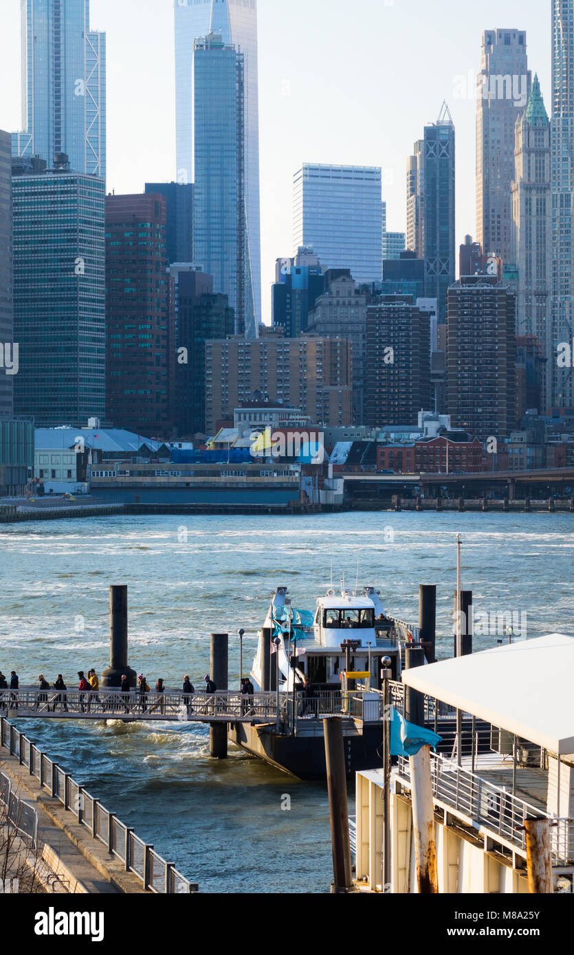 Passengers arriving at Dumbo Station on NYC Ferry with NY skyline seen ...