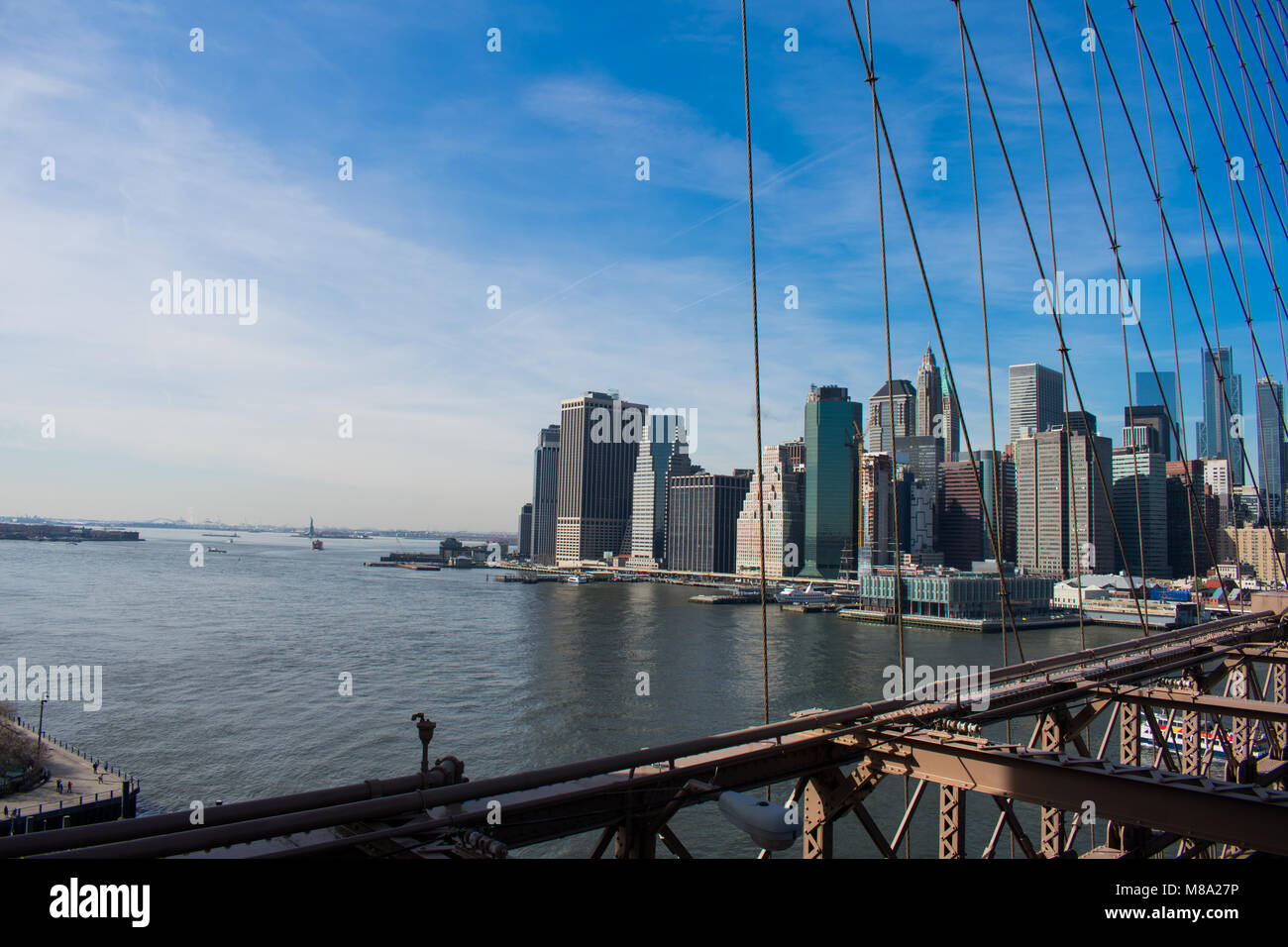 A view of New York City skyline from the Brooklyn Bridge, with lovely ...
