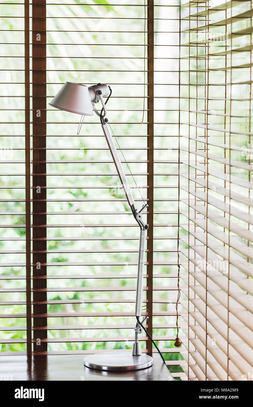 Metal high desk lamp in office, blinds on windows, minimalist style ...