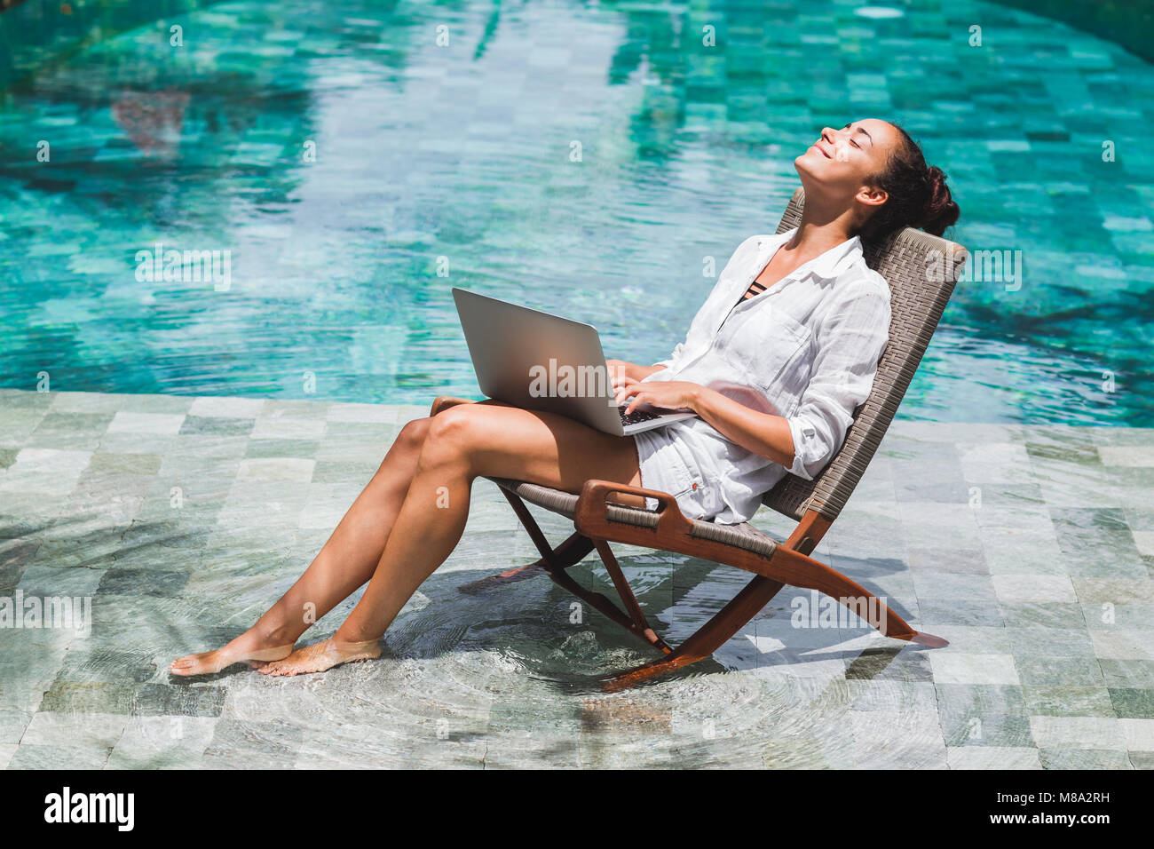Working poolside hi-res stock photography and images - Alamy