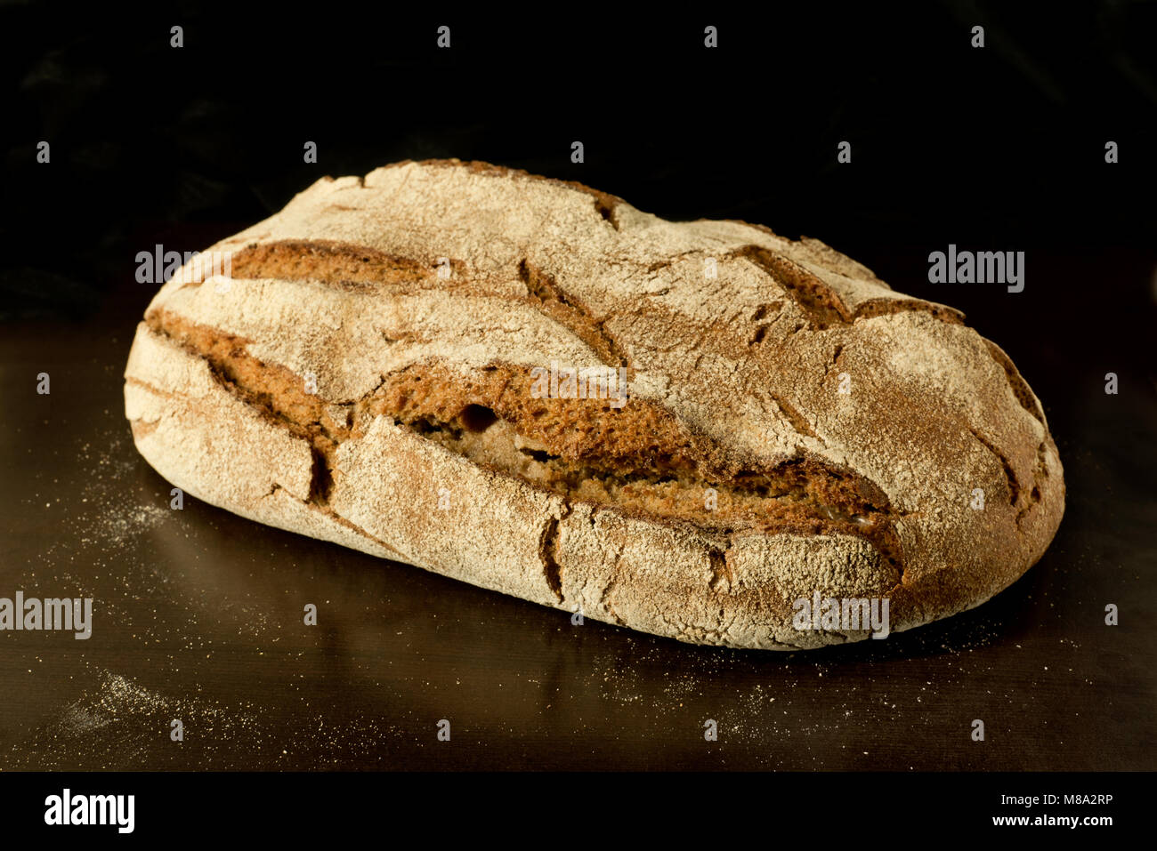 Whole loaf of fresh German sourdough rye bread on dark background Stock ...