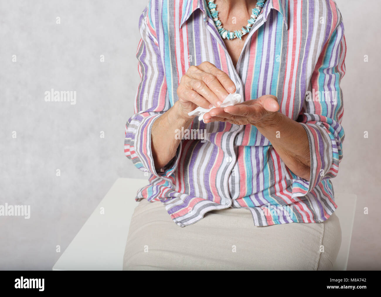 Old Woman Between 70 And 80 Years Old And A Packet Of Wet Wipes Stock