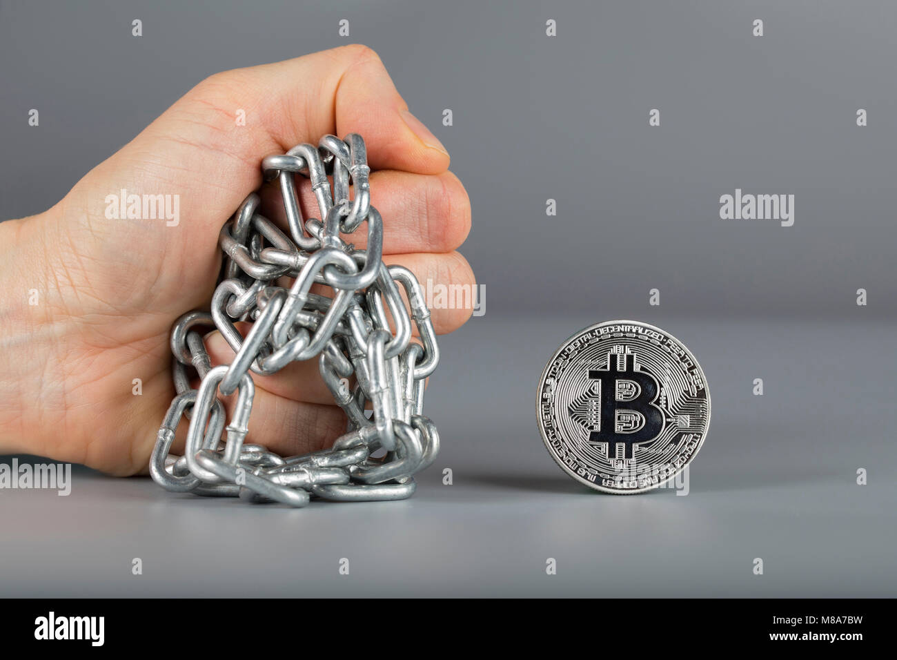 Human fist and bitcoin. Closeup Stock Photo - Alamy
