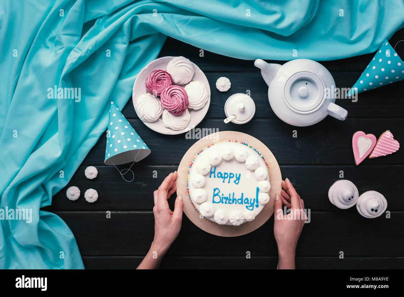 woman putting birthday cake on table Stock Photo - Alamy
