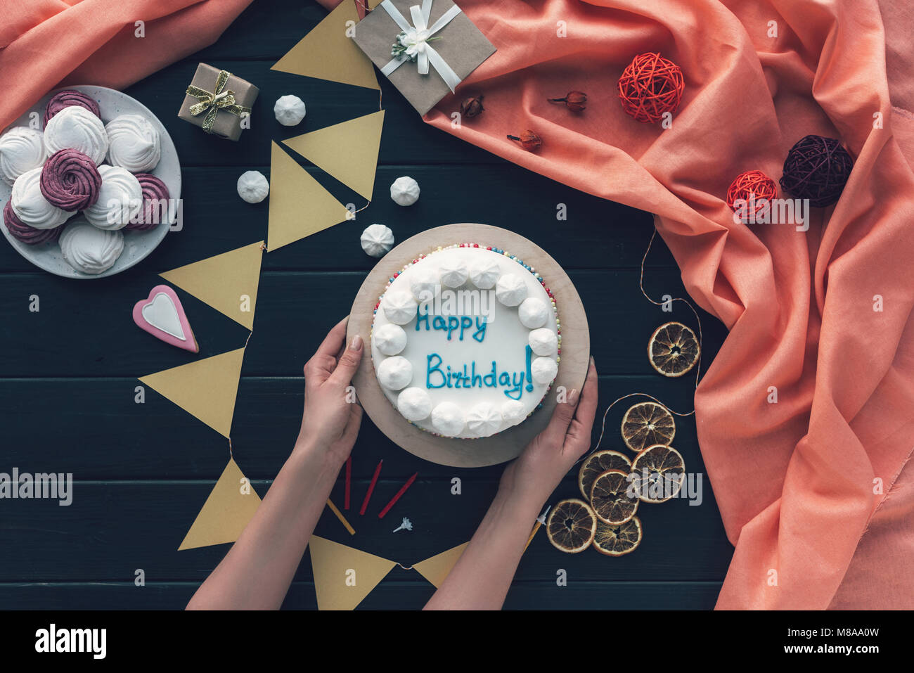 woman putting birthday cake on table Stock Photo - Alamy