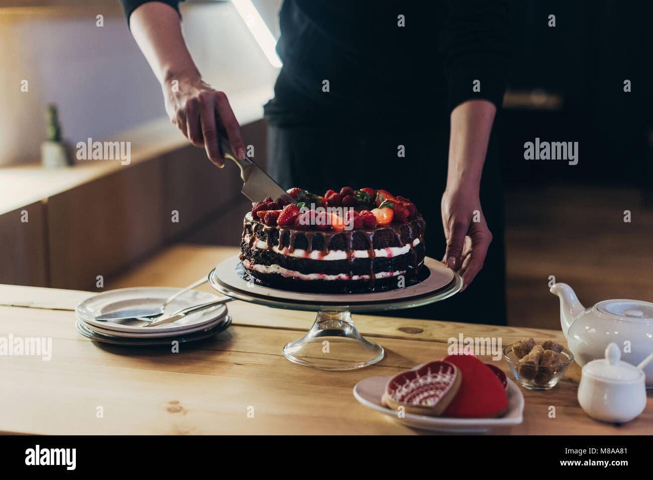 woman cutting chocolate cake Stock Photo - Alamy