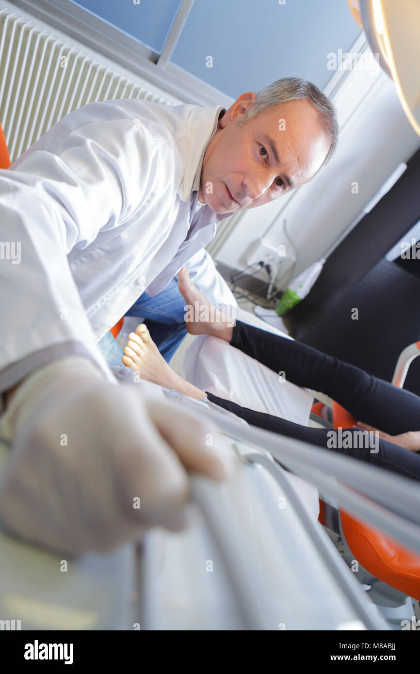 podiatrist cleaning womans feet Stock Photo - Alamy