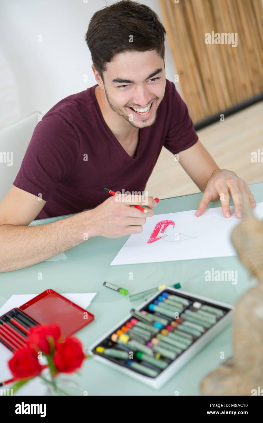 Artist laughing while drawing picture Stock Photo - Alamy