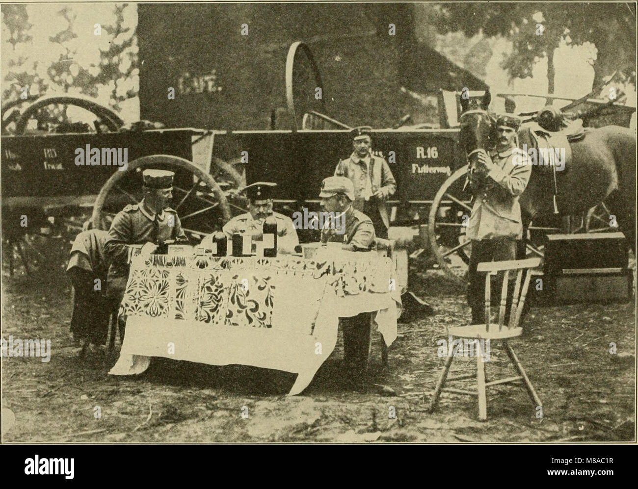 This photograph depicts German officers dining in the field near LiÃ¨ge ...