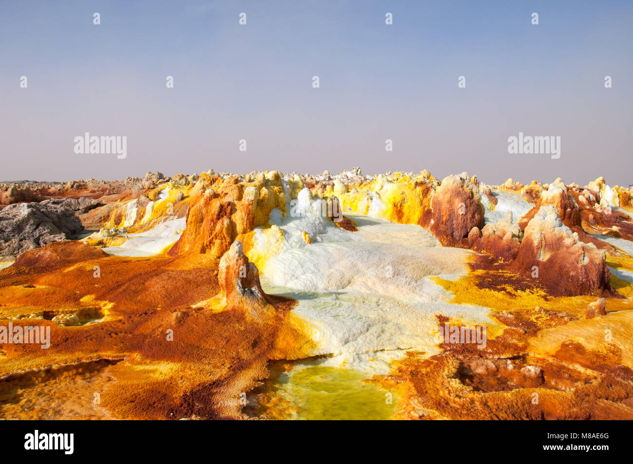 The field is orange sulfuric volcanoes emitting toxic gas clouds ...