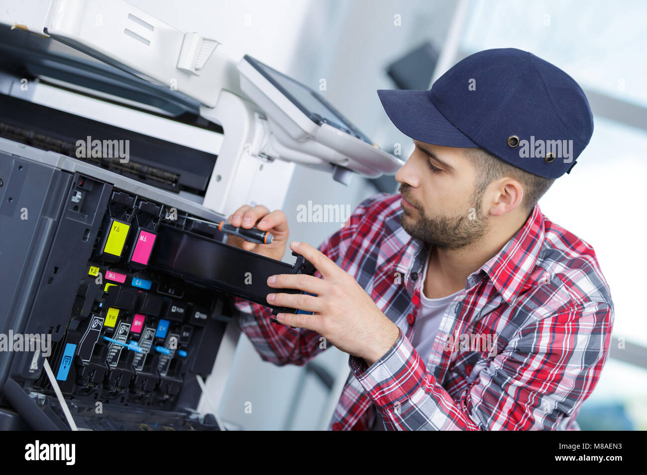 young man fixing printer Stock Photo - Alamy