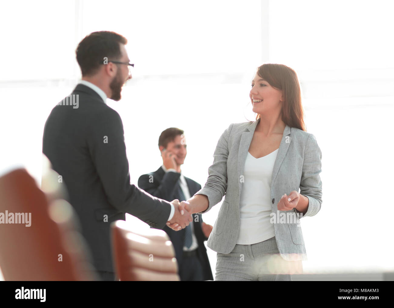 handshake between colleagues in the workplace Stock Photo - Alamy