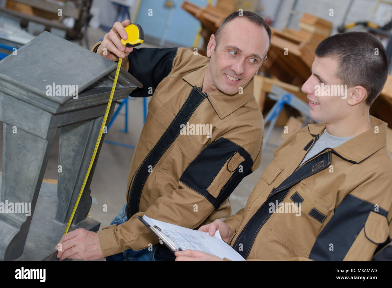 engineer recording precision measurement with his assistant Stock Photo ...