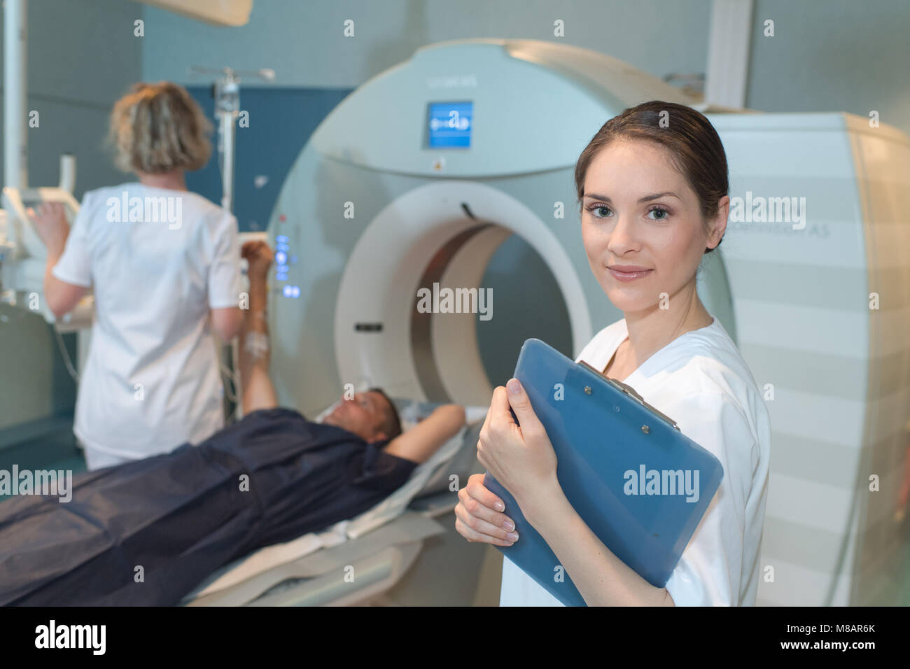 female patient undergoing ct scan test in examination room Stock Photo ...