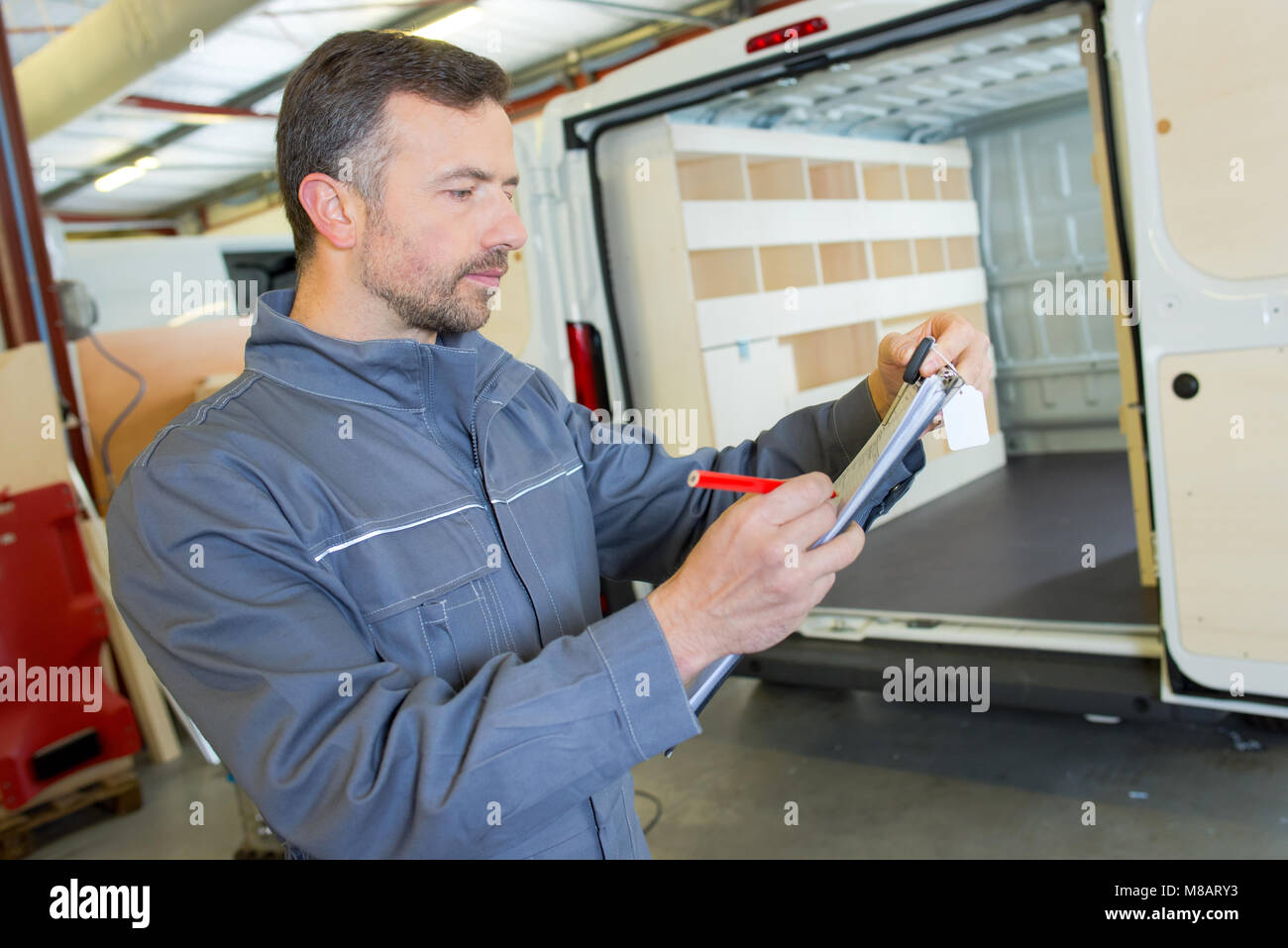 warehouse worker reading the report Stock Photo - Alamy