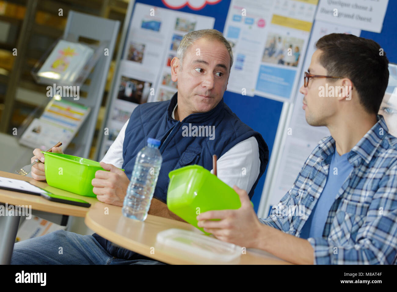 two colleagues having a lunch break at work Stock Photo - Alamy