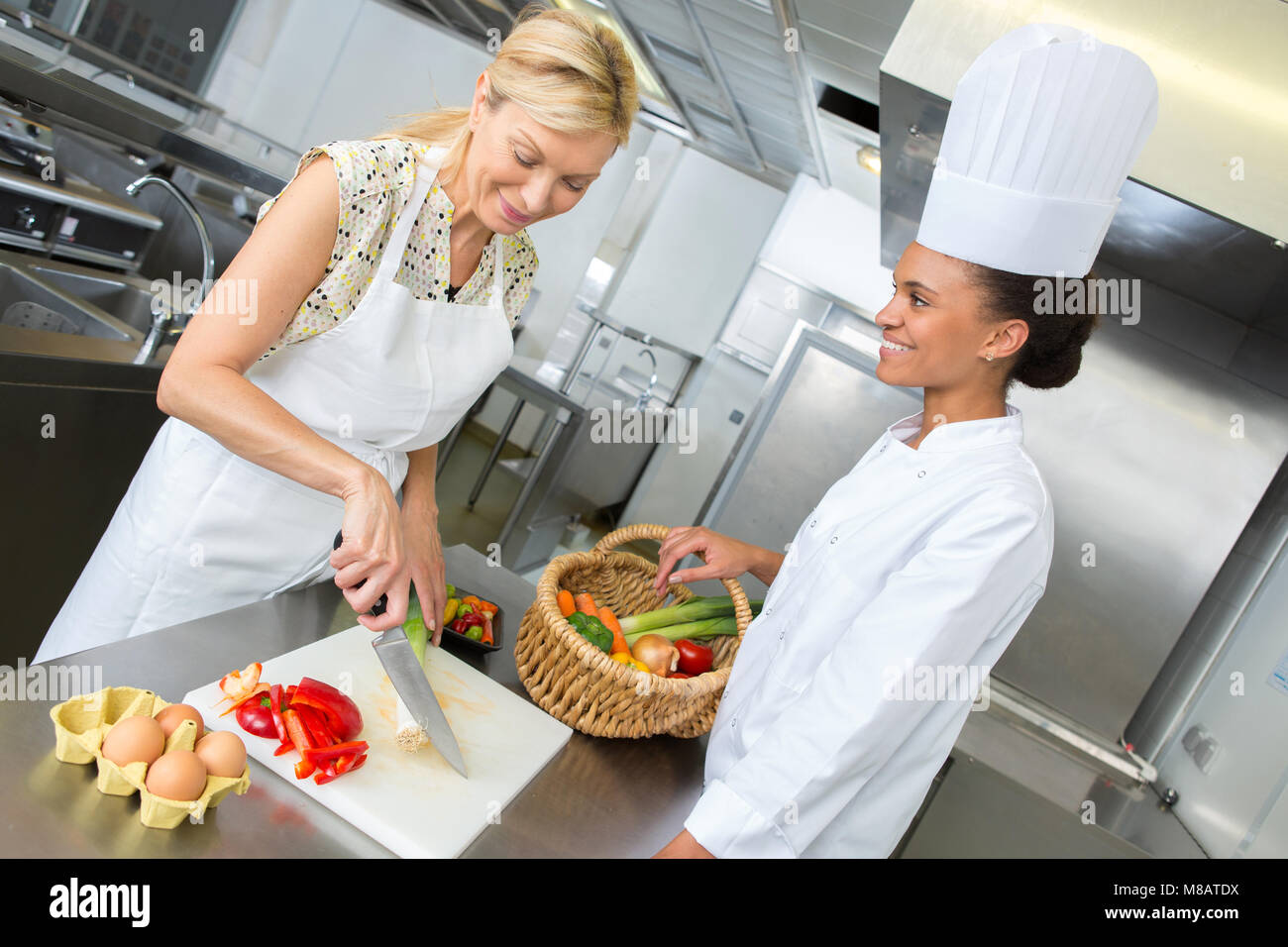 Female chefs prepping vegetables Stock Photo - Alamy