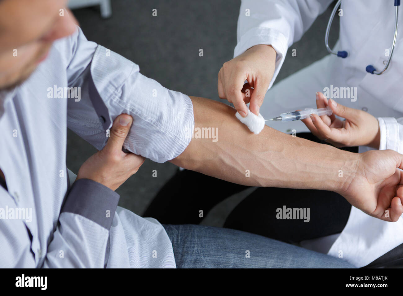 woman doctor gets an injection to a man Stock Photo - Alamy
