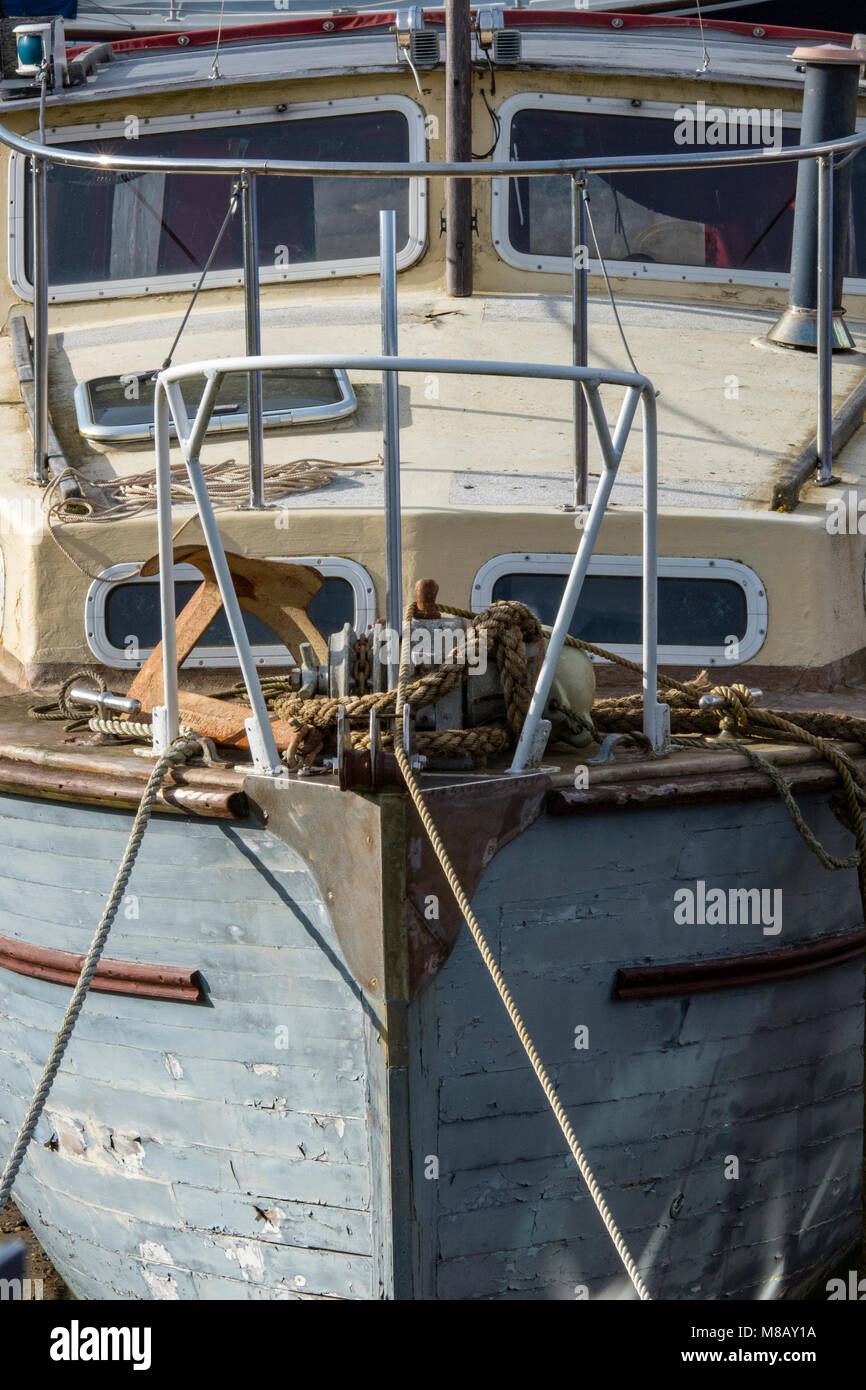 The bows of an old wooden motor cruiser or pleasure leisure boat moored ...