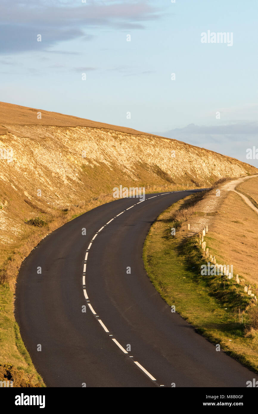 A road running through the hills or mountains empty and disappearing ...