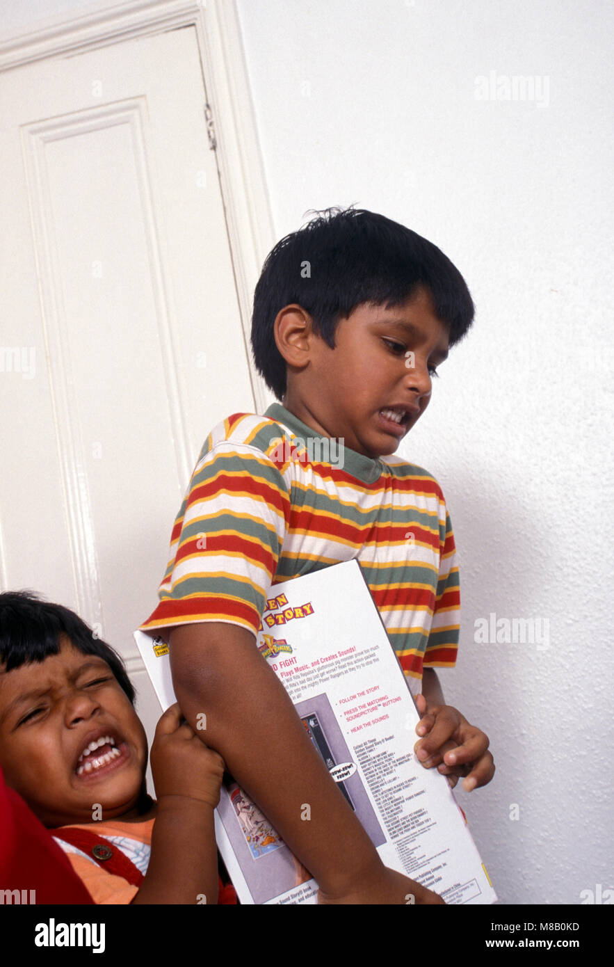Asian brothers squabbling Stock Photo - Alamy