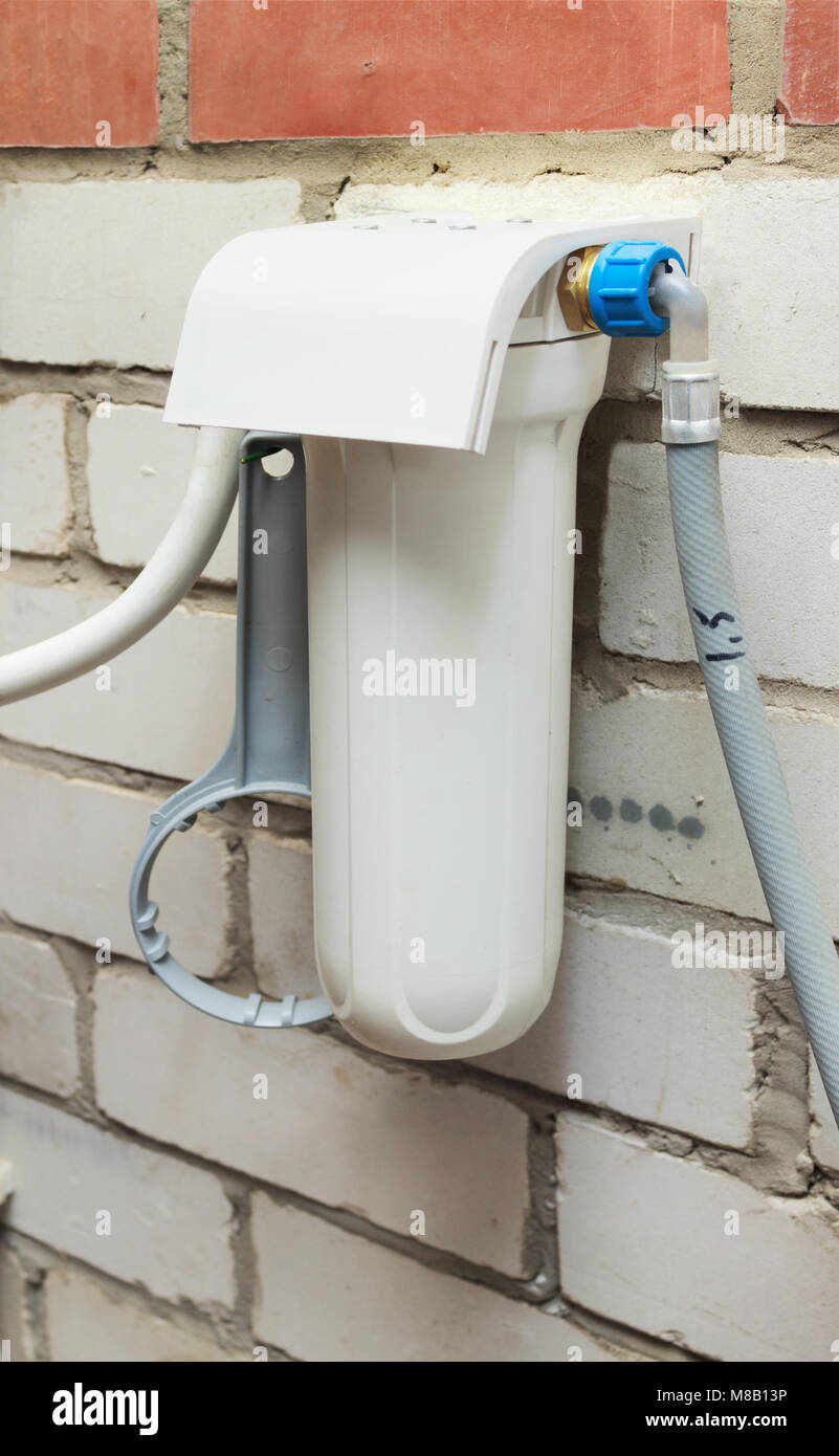 Housing water filter is mounted on a brick wall Stock Photo - Alamy
