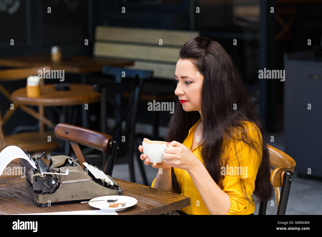 Freelance and writing concept. Writer female with dark long hair ...