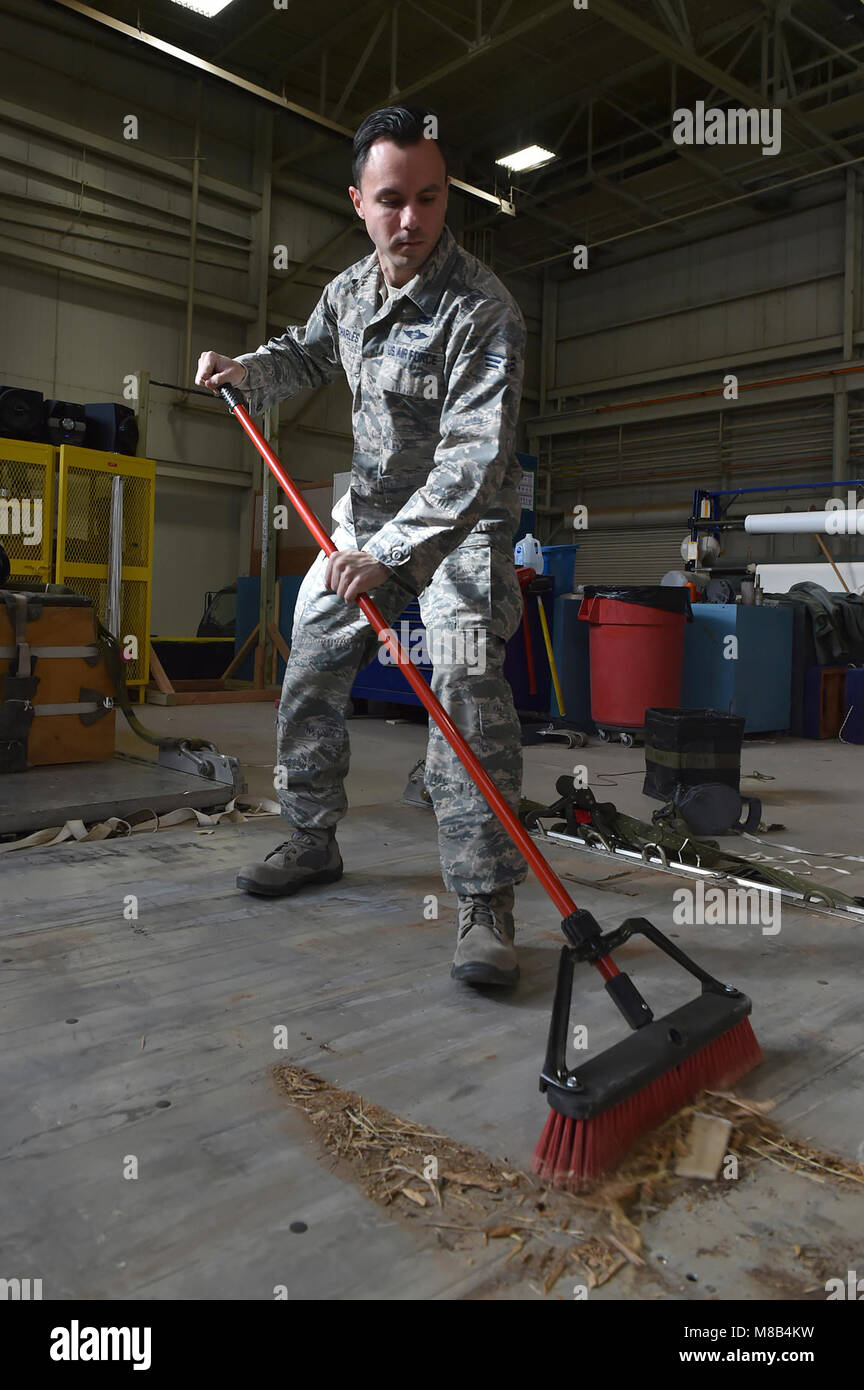Sweeping the workshop floor Stock Photo - Alamy