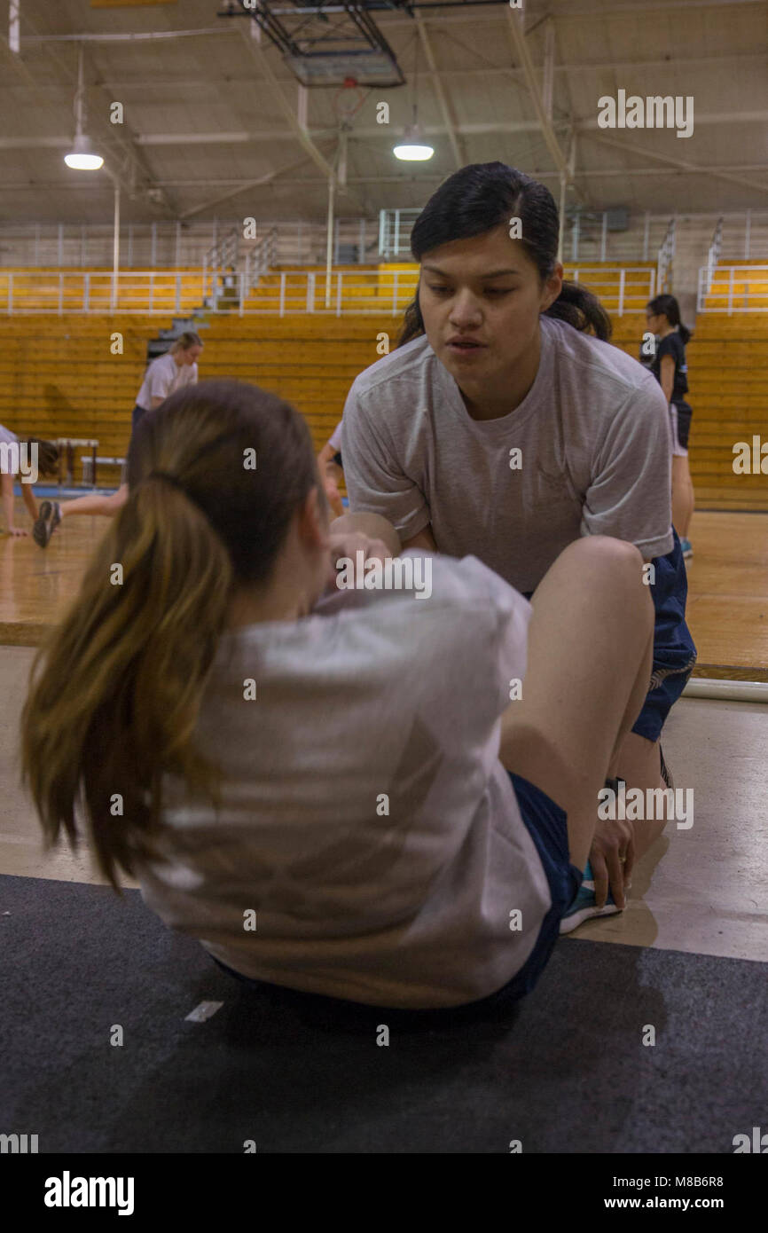 HANSCOM AIR FORCE BASE, Mass. – Air Force Cadet Vella holds the feet of ...