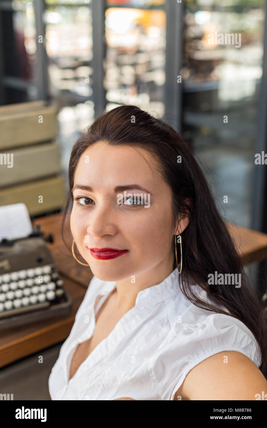Head and shoulders portrait of self-confident writer female wearing ...