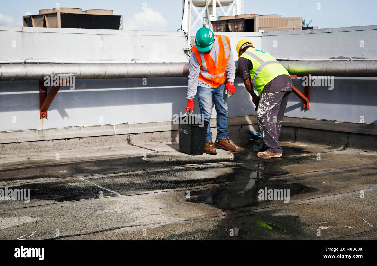 Bayamón, Puerto Rico, February 23, 2018 - Contractors clean roof at the ...