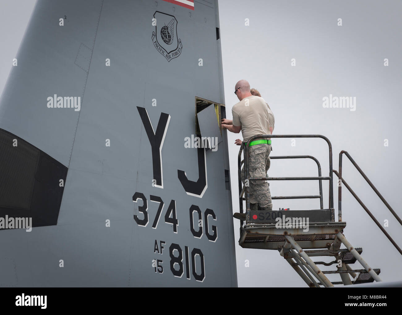 Airmen assigned to the 374th Maintenance Group perform maintenance on a ...