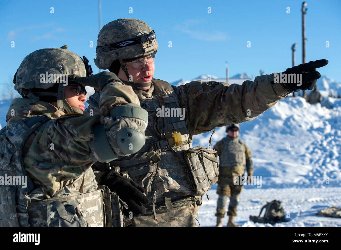 Staff Sgt. David Riley, right, coaches Pfc. Miranda Argueta during M249 ...