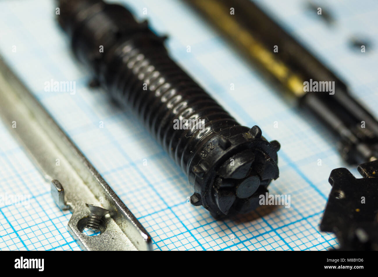 parts are completely disassembled old retro film SLR camera on graph ...